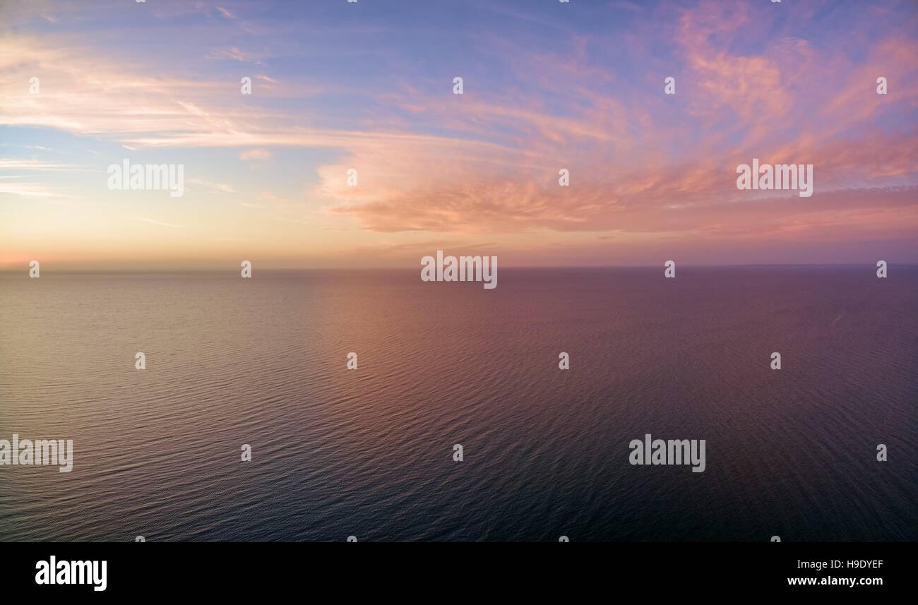 Aerial panoramic view of sunset over ocean. Nothing but sky, clouds and ...