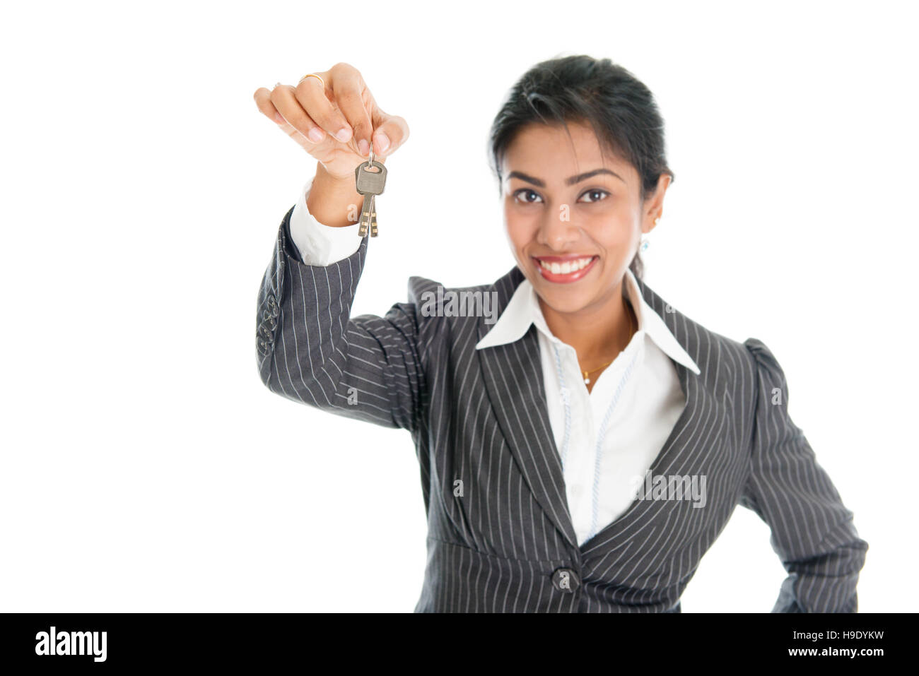 Realtor showing house key and smiling, isolated on white background ...
