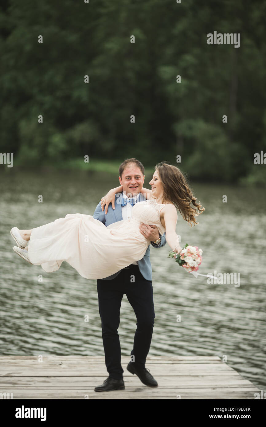 Bride carrying the groom hi-res stock photography and images - Alamy