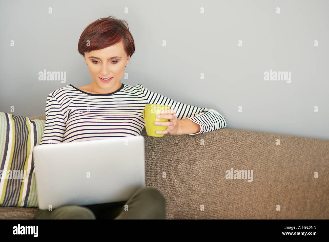Drinking good coffee and working on laptop Stock Photo - Alamy