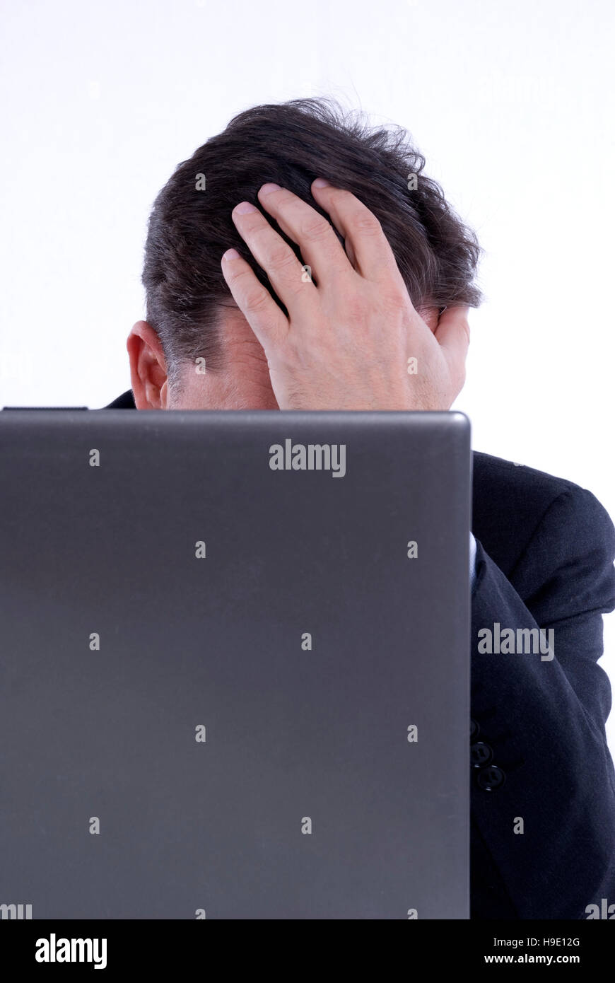 Despairing businessman, working on a computer Stock Photo - Alamy
