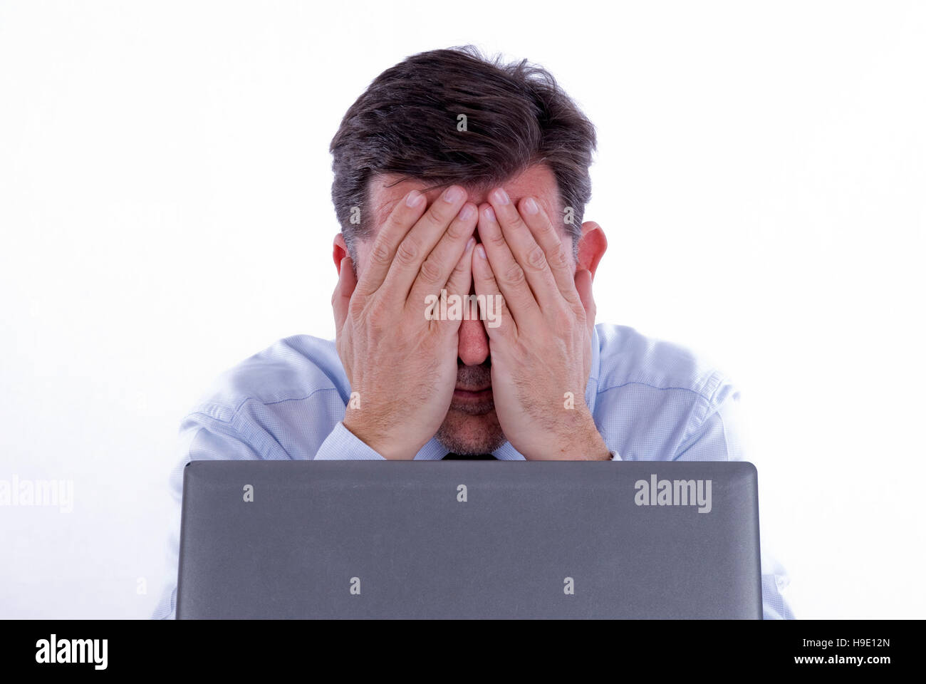 Despairing businessman, working on a computer Stock Photo - Alamy