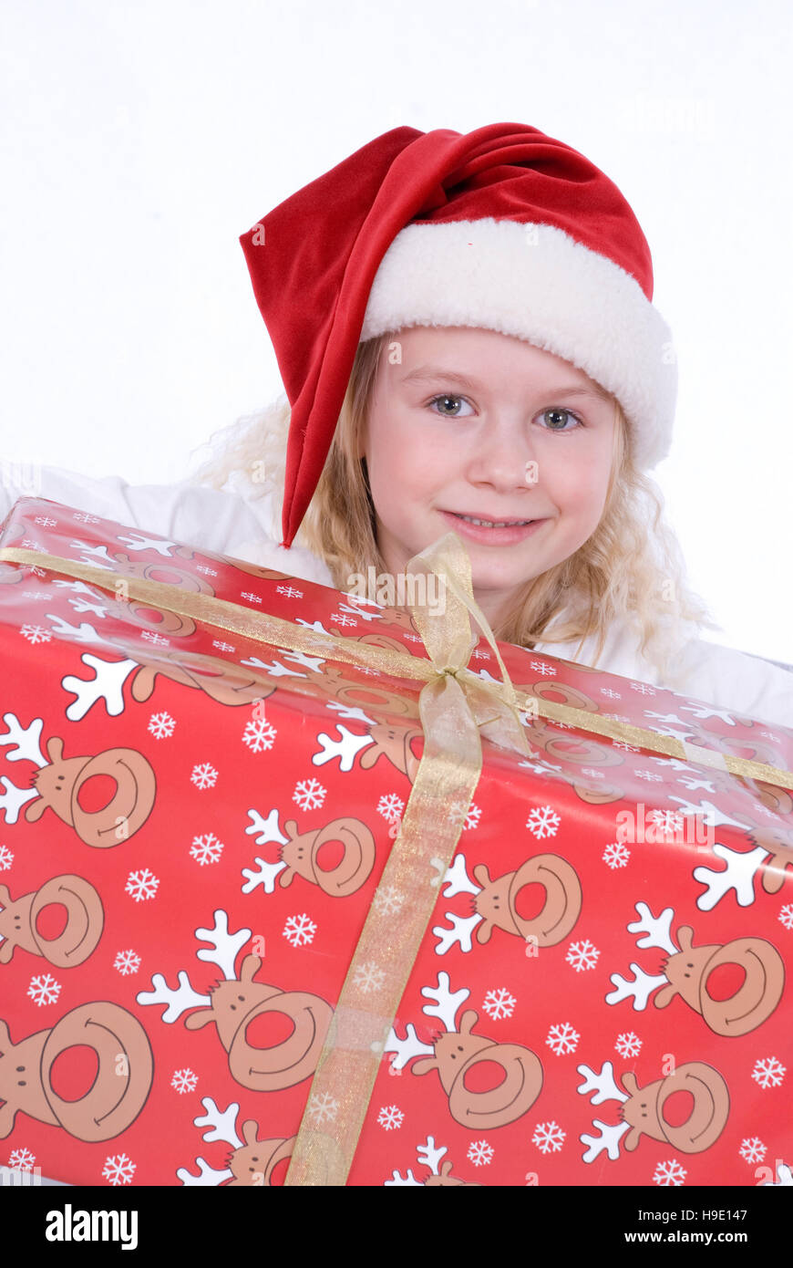 Portrait of a girl wearing a santa hat smiling hi-res stock photography ...