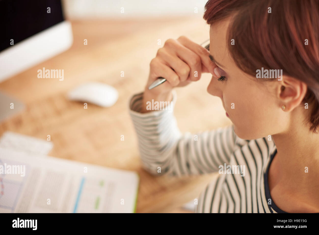 Strong headache during work over documents Stock Photo - Alamy