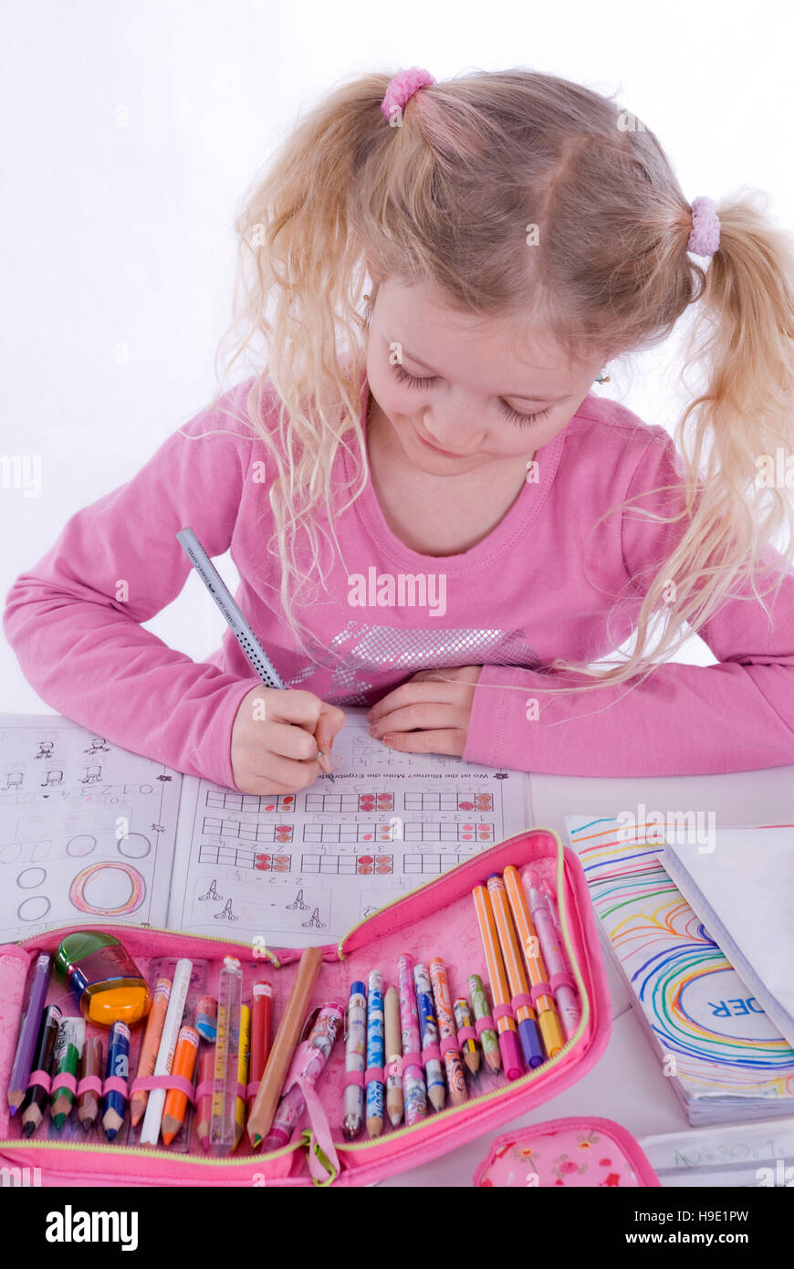 Seven-year-old schoolgirl doing homework Stock Photo - Alamy