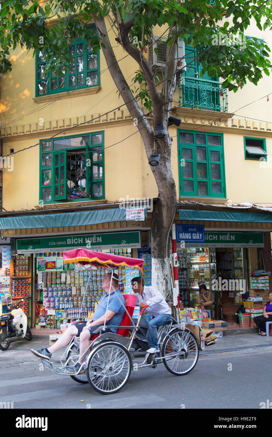 Tourist riding in tricycle rickshaw in Old Quarter, Hanoi, Vietnam ...
