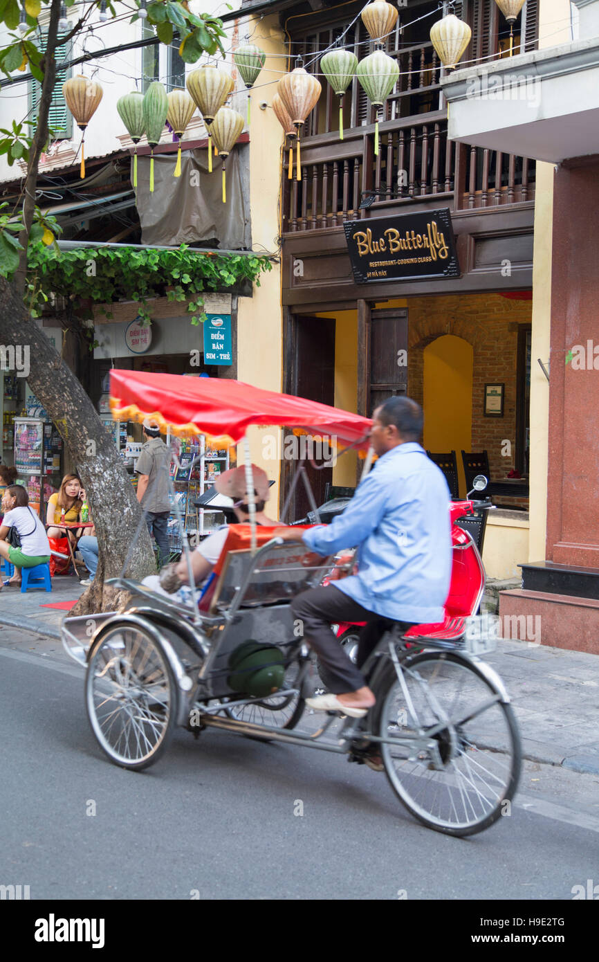 Tourist riding in tricycle rickshaw in Old Quarter, Hanoi, Vietnam ...