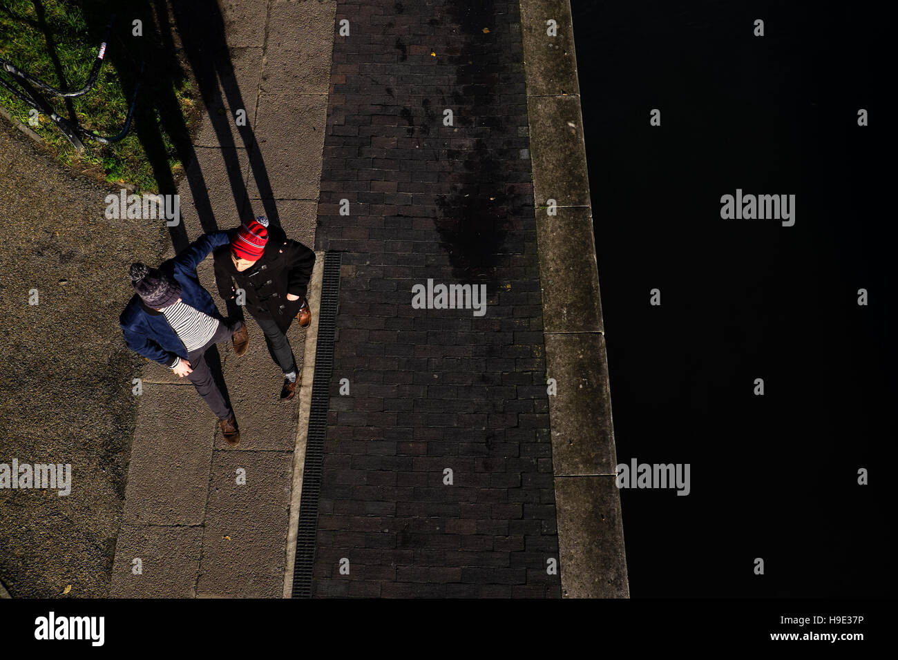 Lovers in matching bobble hats walk along the Regents Canal (near ...