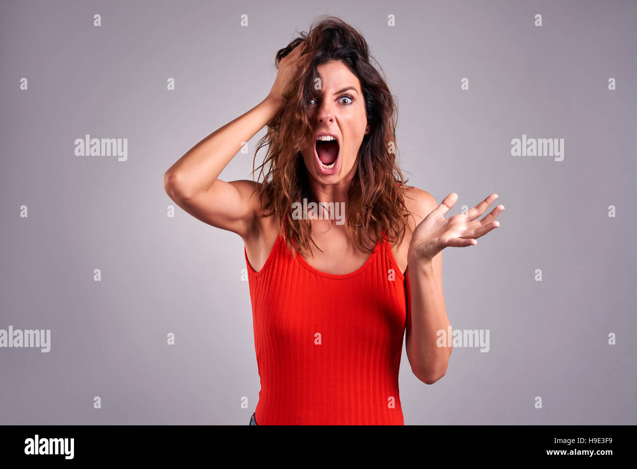 A beautiful young woman screaming furiously Stock Photo - Alamy