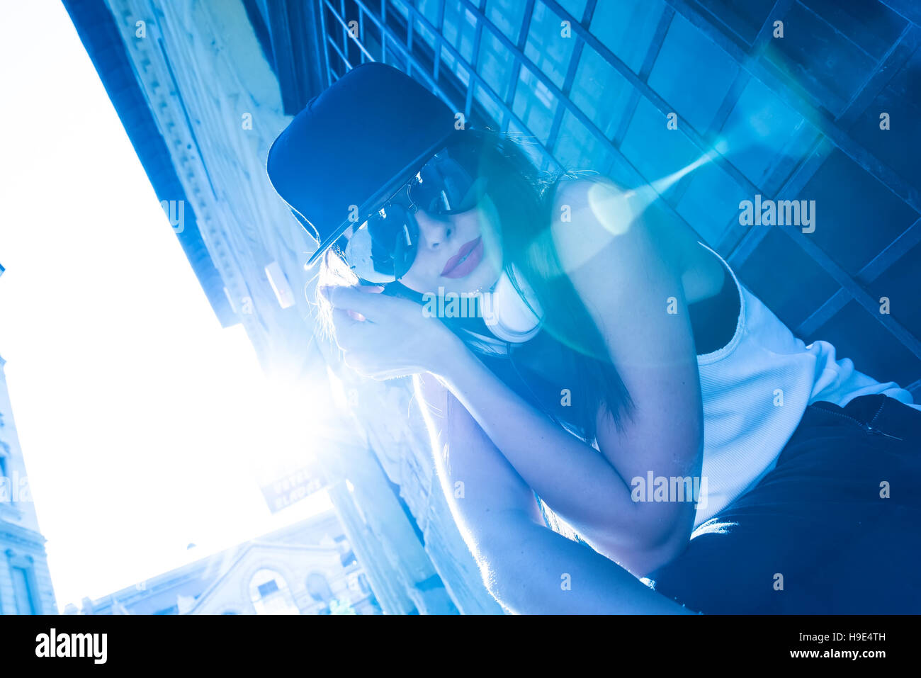 A beautiful young Hip Hop Rapper girl with Headphones in a urban ...