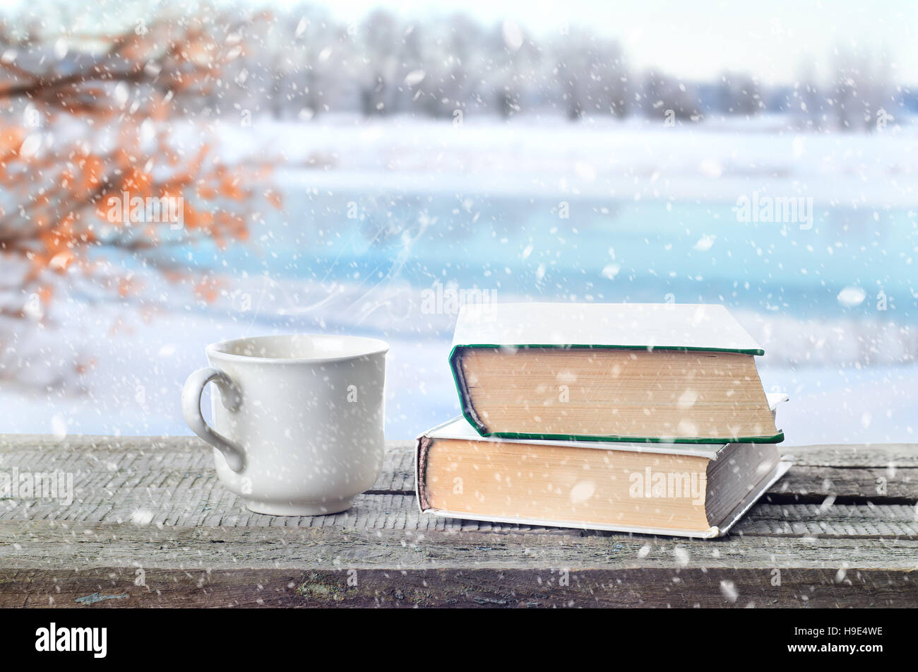 Cup hot coffee or tea, cocoa, chocolate and book outdoors on wooden ...