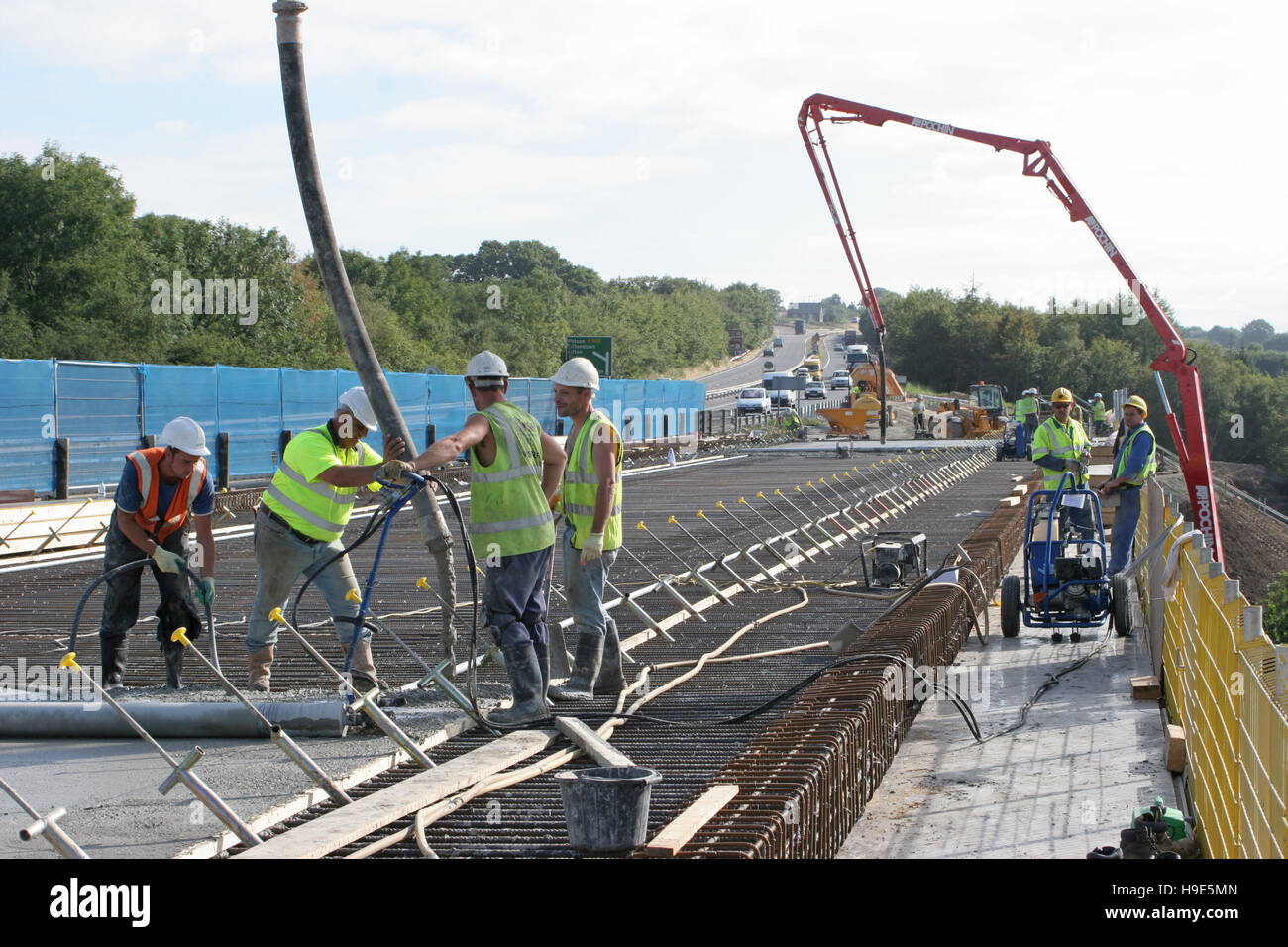 Concrete is pored during the construction of a new road bridge on the ...