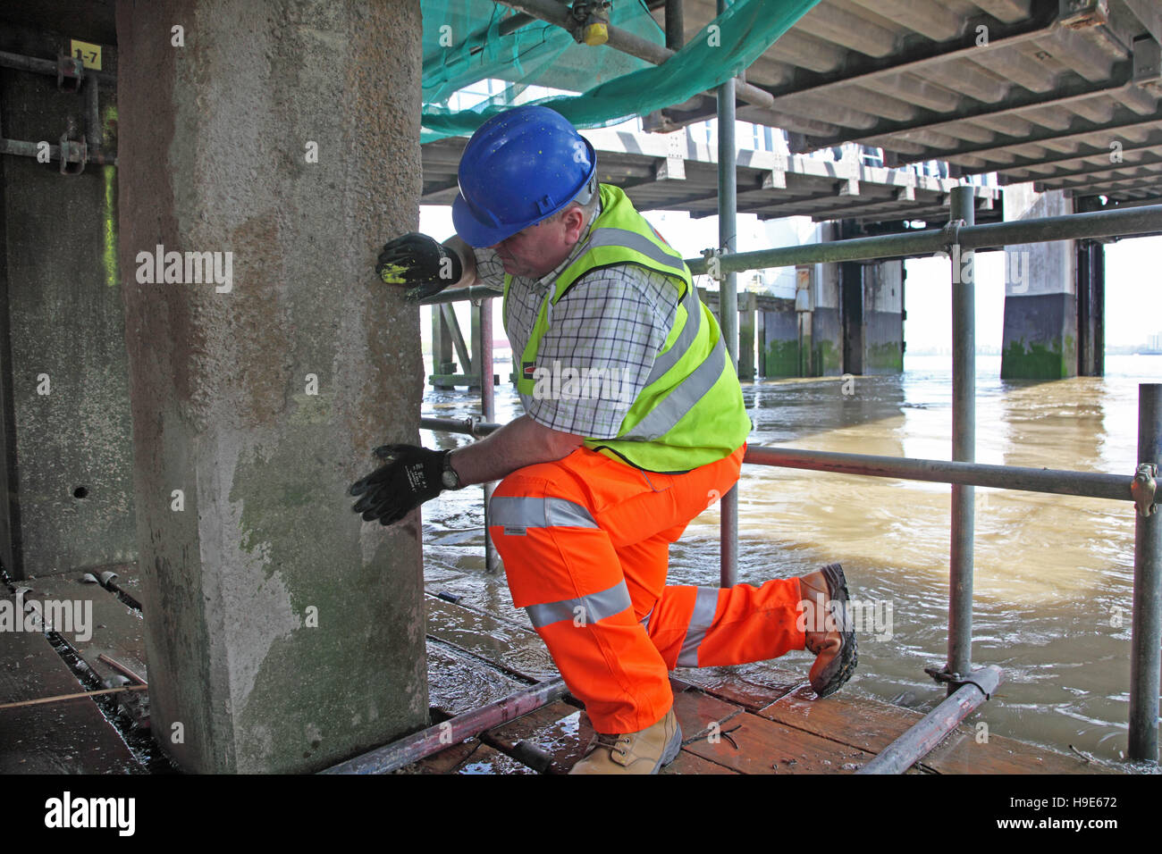 Maintenance work is assessed on the concrete frame supporting the ...
