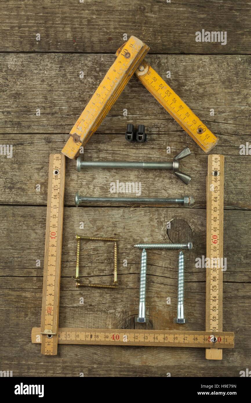 Plans to build a house. Rustic wooden background. Tools for builders ...