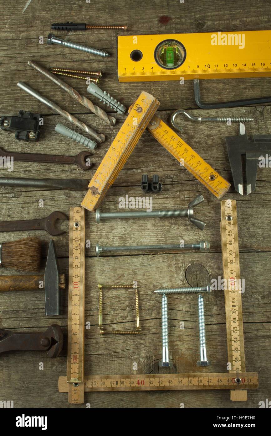 Plans to build a house. Rustic wooden background. Tools for builders ...