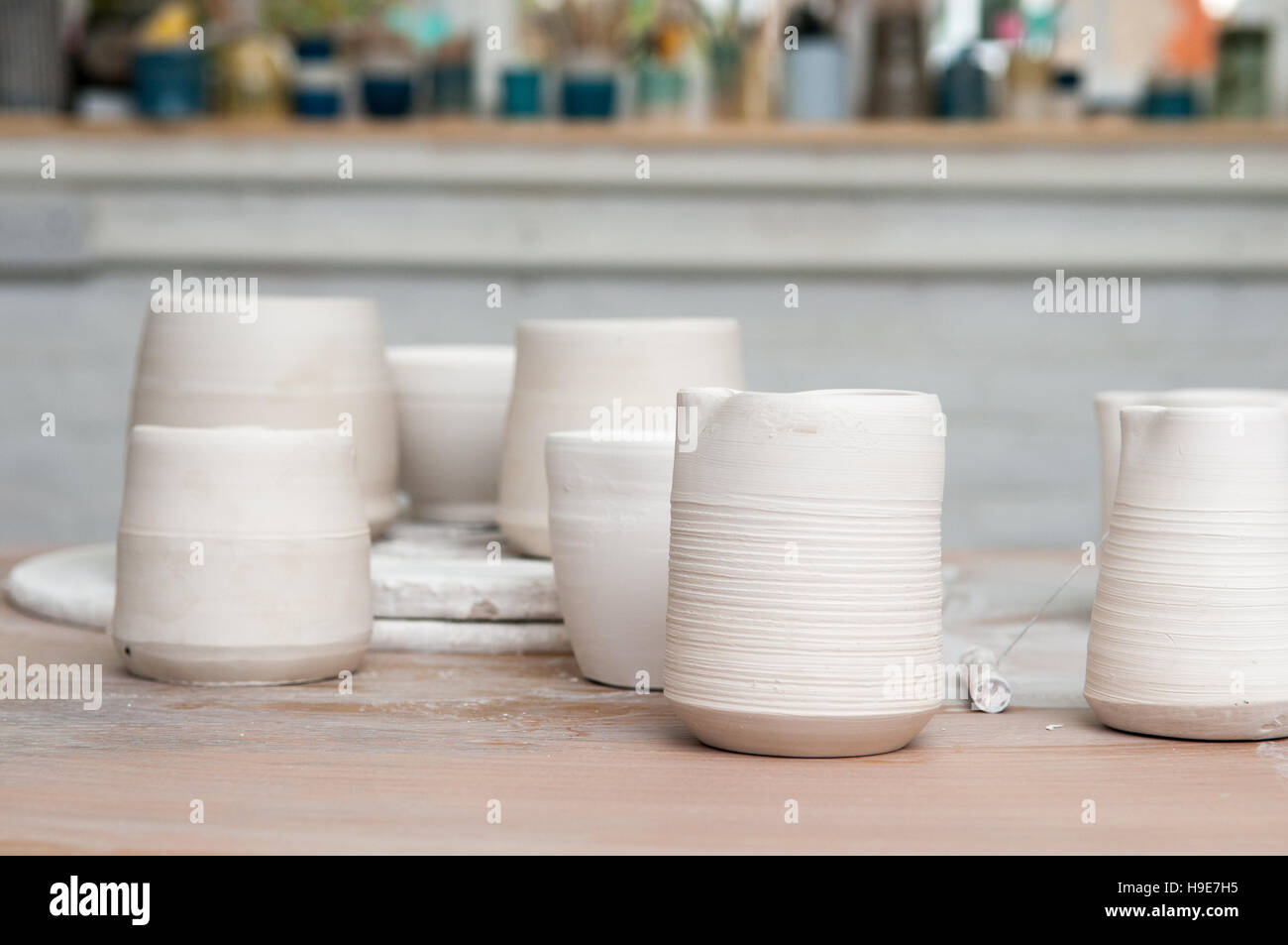 Hand made clay pots in a pottery workshop background Stock Photo - Alamy