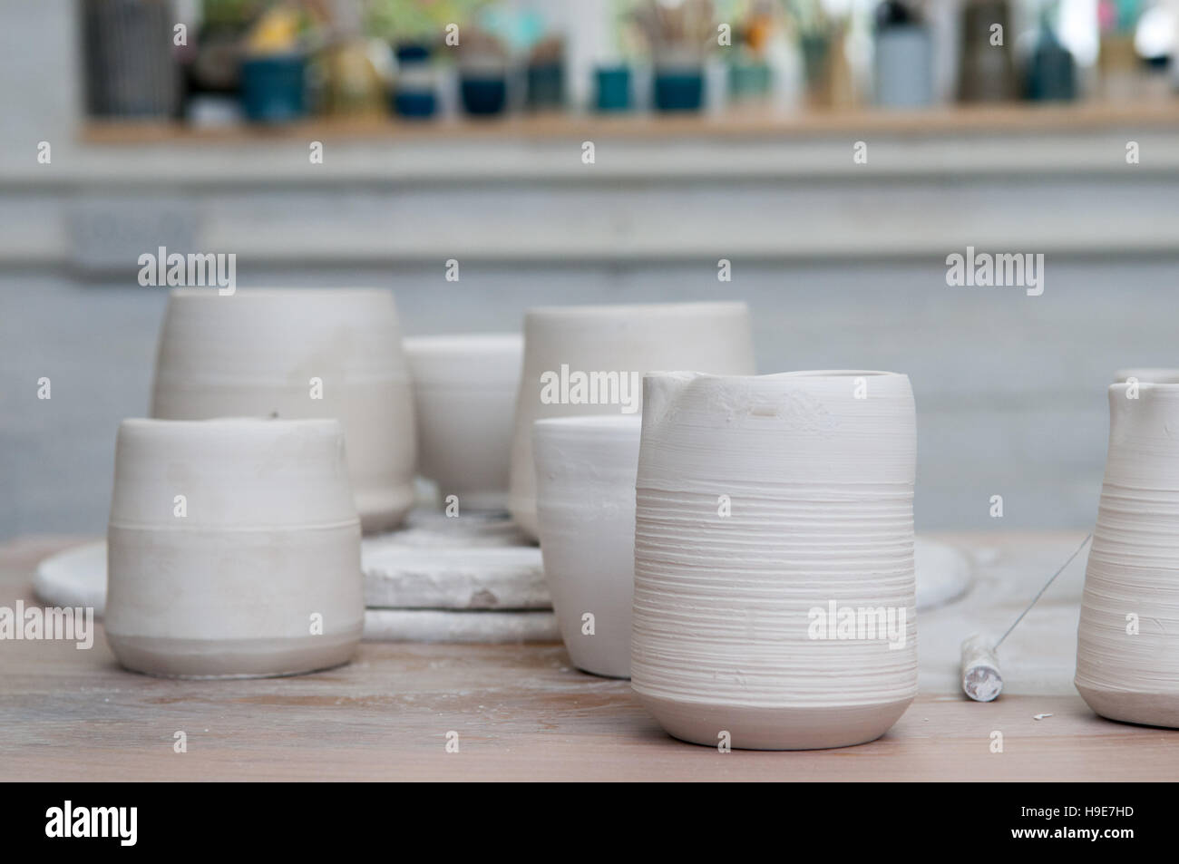 Hand made clay pots in a pottery workshop background Stock Photo - Alamy
