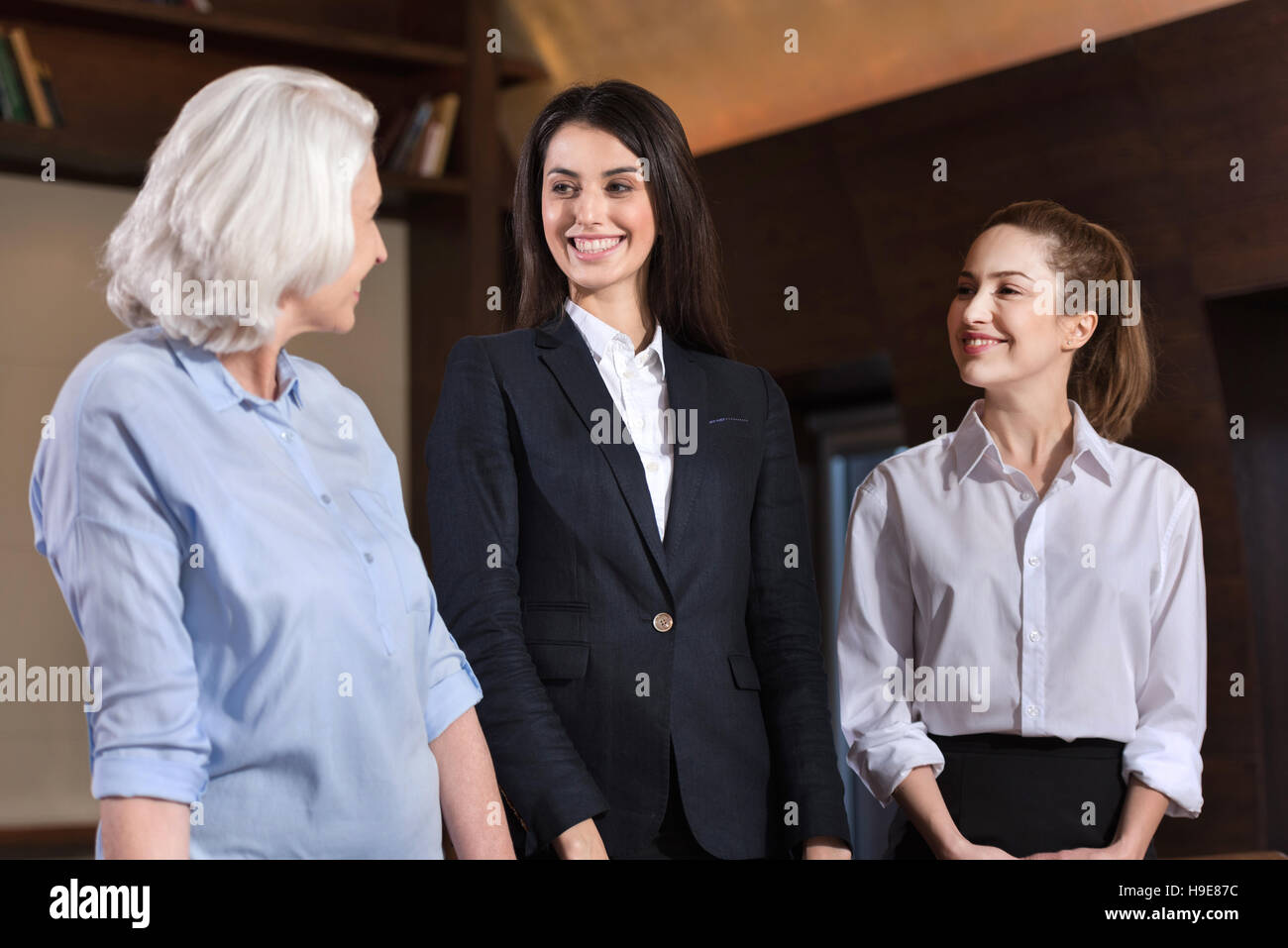 Three colleagues communicating happily in an office Stock Photo - Alamy