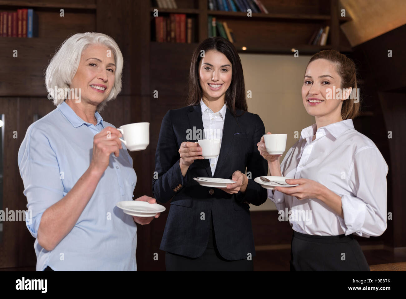 Female colleagues posing during coffee break Stock Photo - Alamy