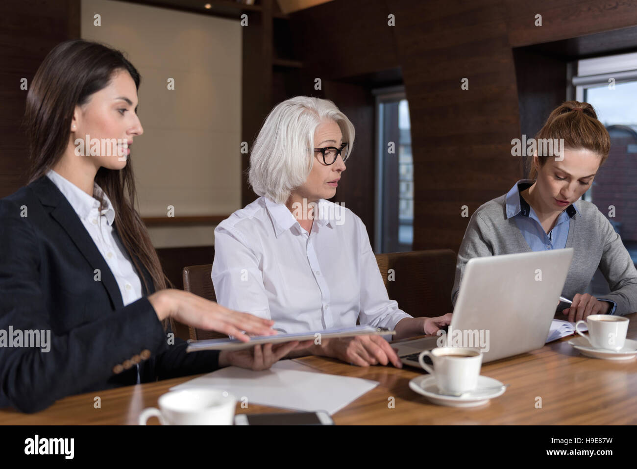 Female colleagues enjoying work together Stock Photo - Alamy