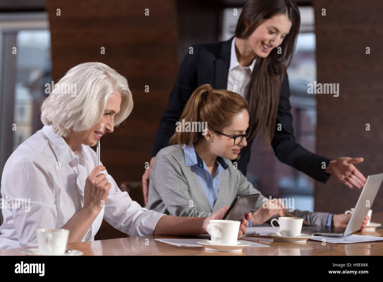 Female colleagues working on their project properly Stock Photo - Alamy
