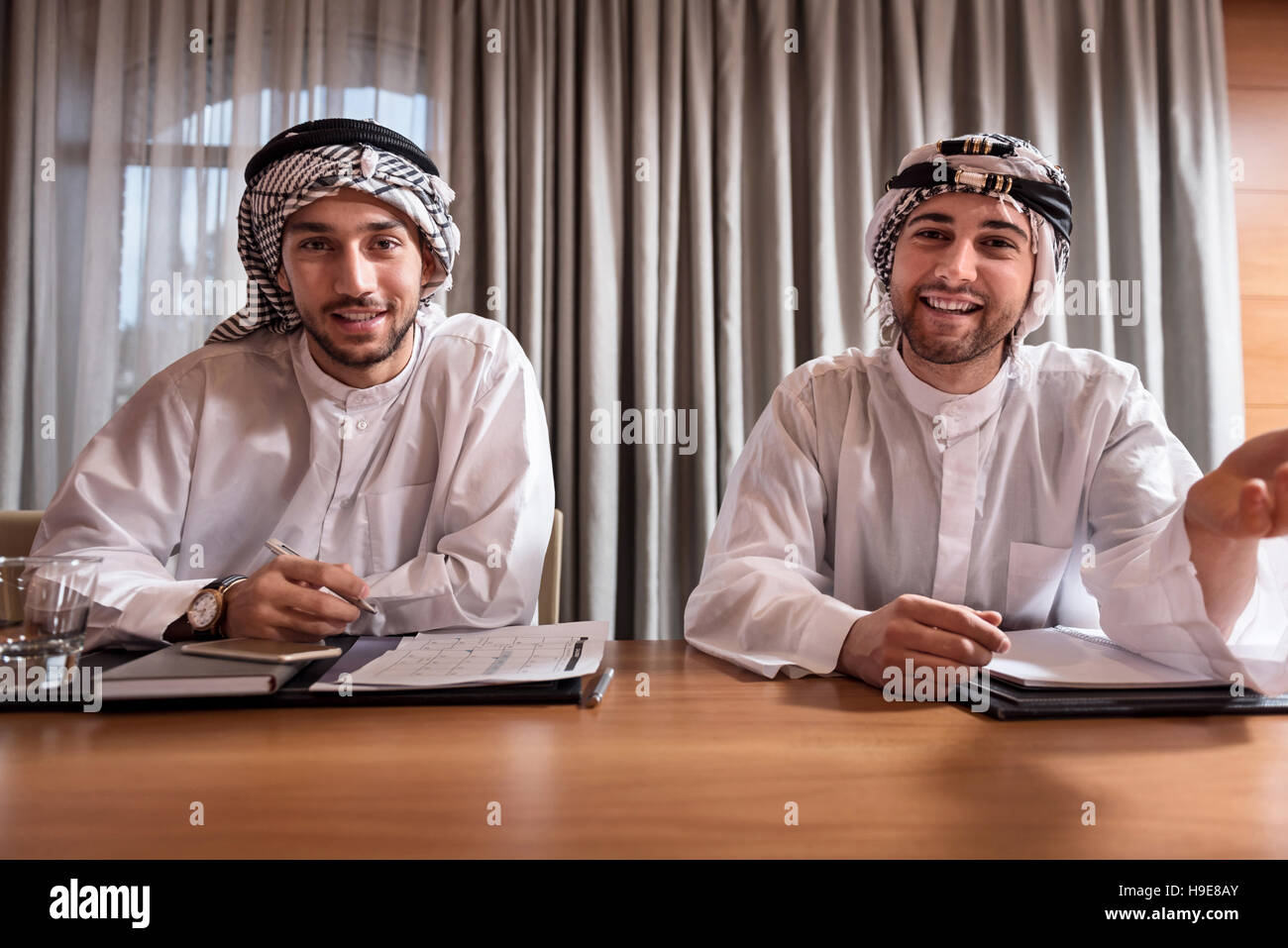 Two happy bearded workers at the table Stock Photo - Alamy
