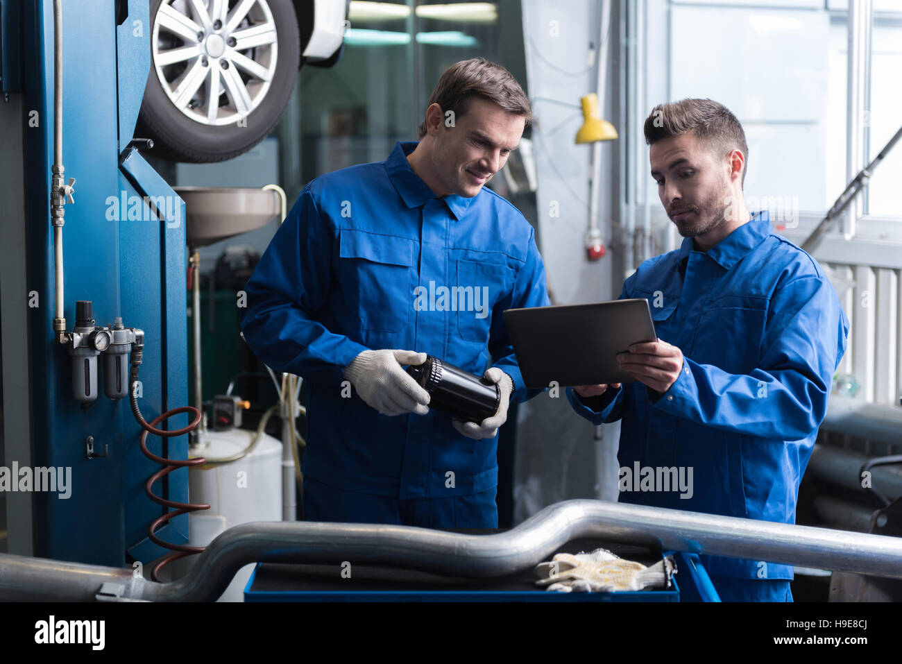 Positive mechanics standing in auto service Stock Photo - Alamy
