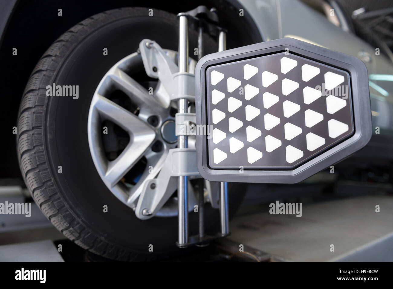 Car wheel fixed in alignment machine clap Stock Photo - Alamy