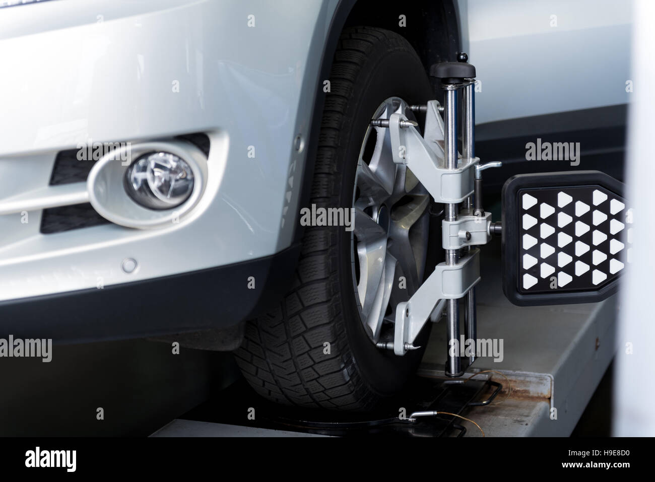 Car wheel adjusted with automobile alignment Stock Photo - Alamy