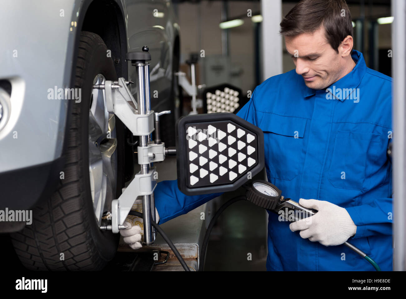 Professional mechanic chacking cars wheel system Stock Photo - Alamy