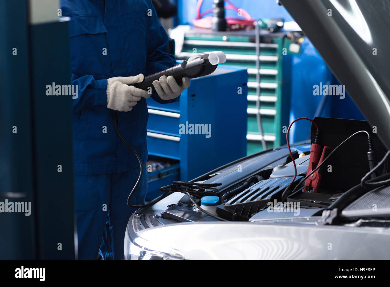 Professional mechanic checking car engine Stock Photo - Alamy
