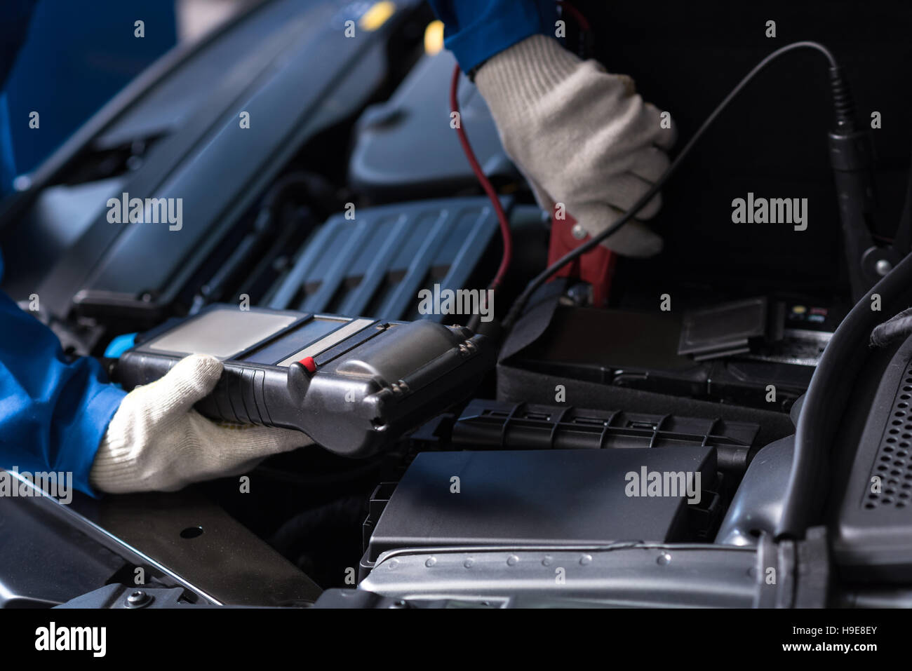 Professional mechanic examining car engine Stock Photo - Alamy