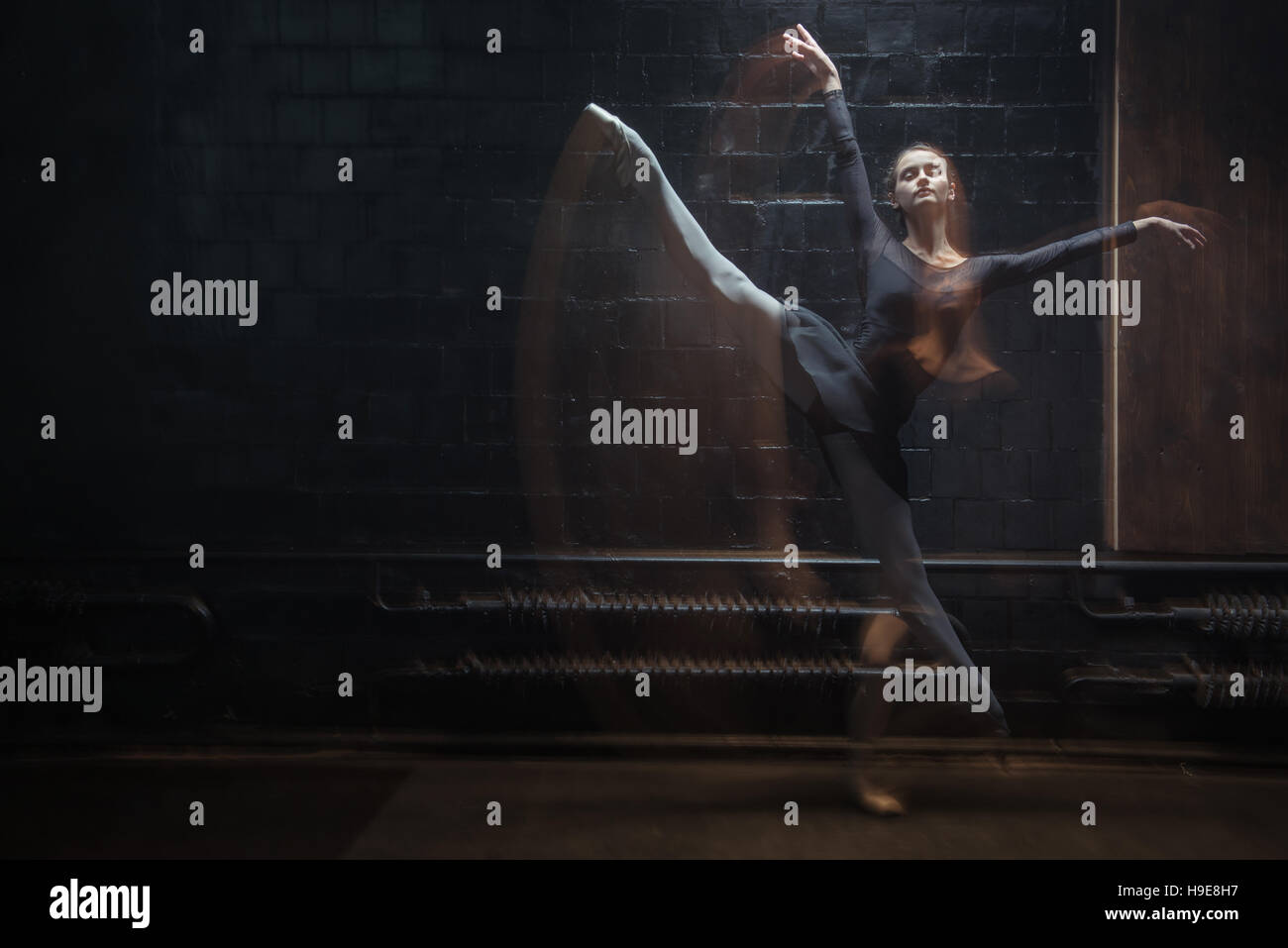 Young dancer jumping in front of the black wall Stock Photo - Alamy