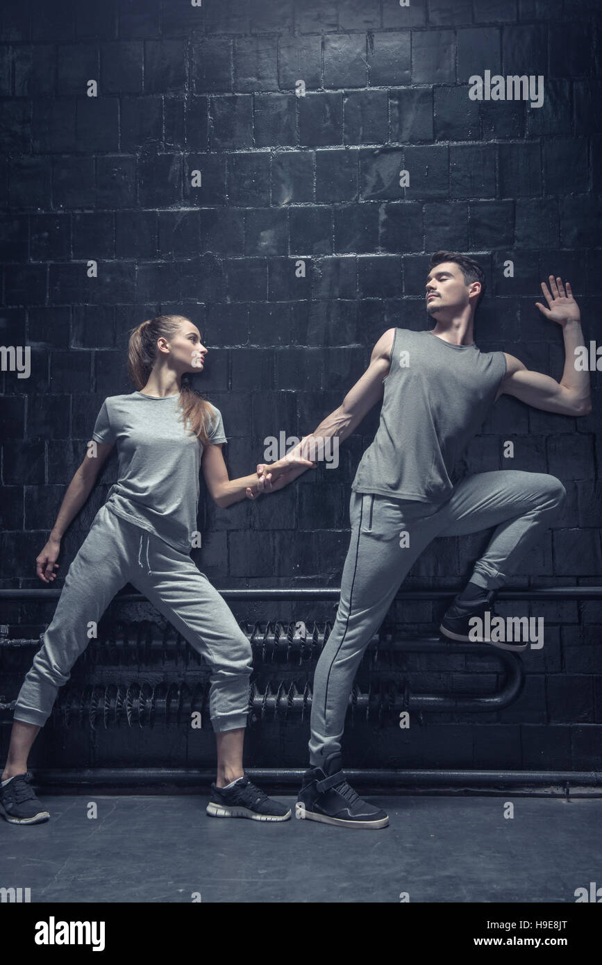 Pleasant athletes performing in close interaction with each other Stock ...