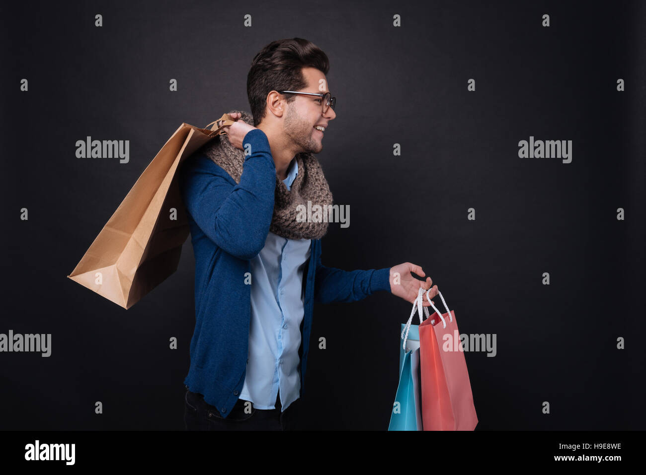 Positive man enjoying shopping Stock Photo - Alamy