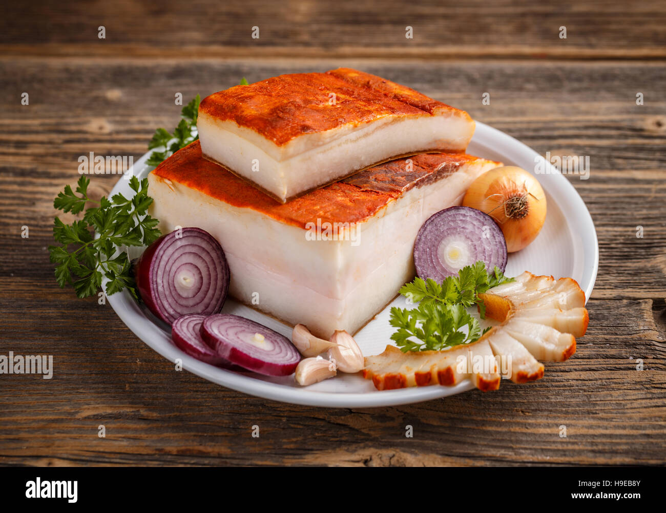 Smoked fat bacon with parsley and onion Stock Photo - Alamy