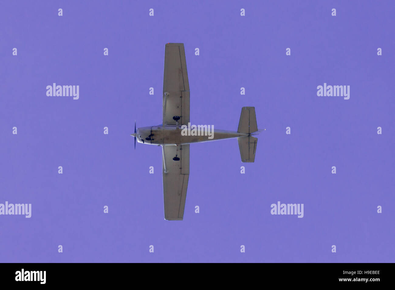 Small single engine airplane flying in the clear blue sky. The airplane ...