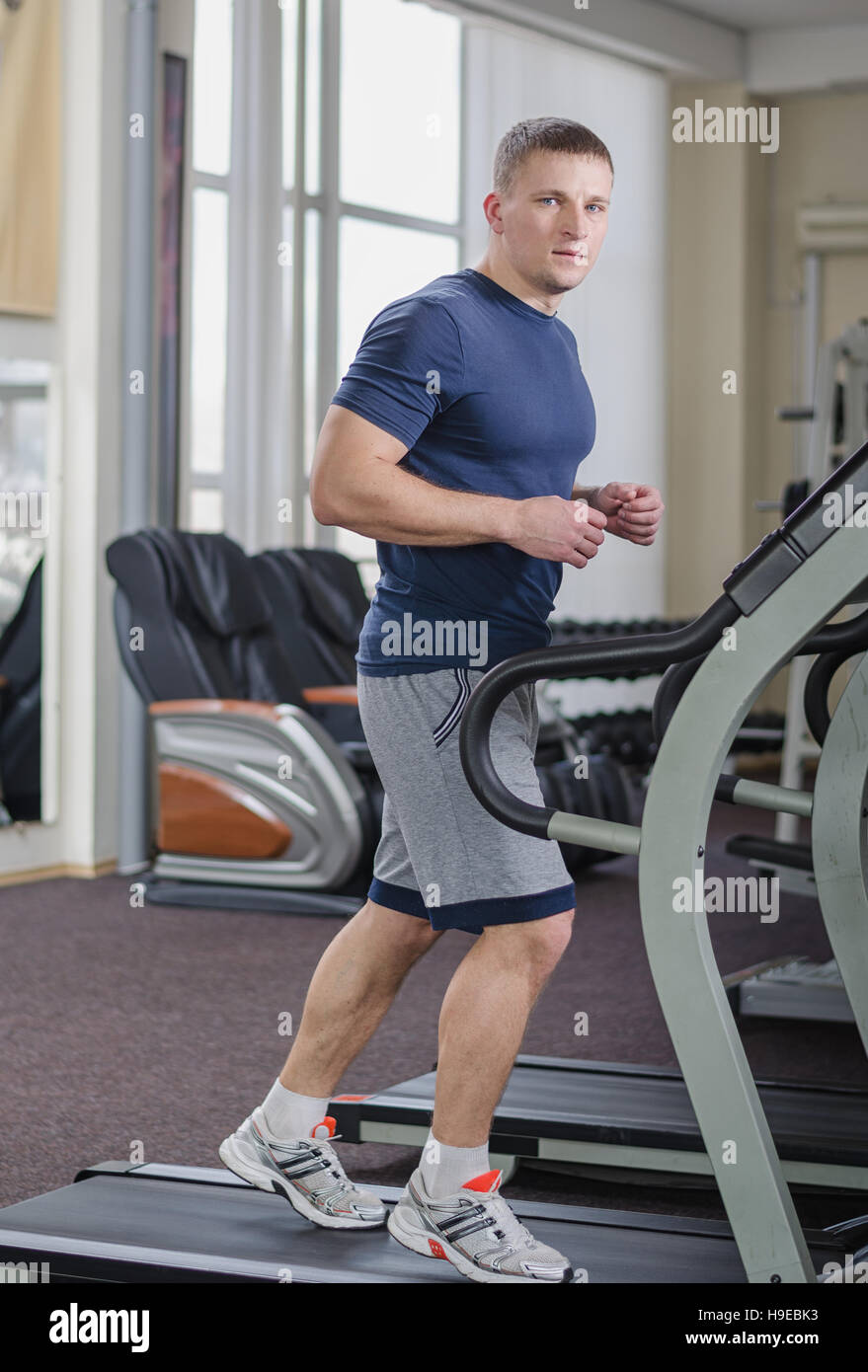 Young athlete running at the gym on the treadmill Stock Photo - Alamy