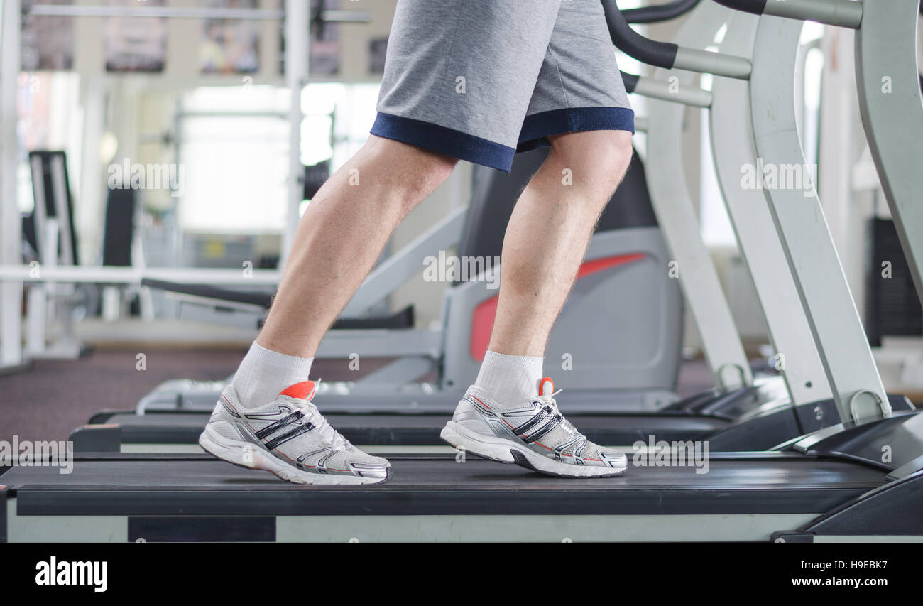 Muscular male legs on a treadmill at the gym Stock Photo - Alamy