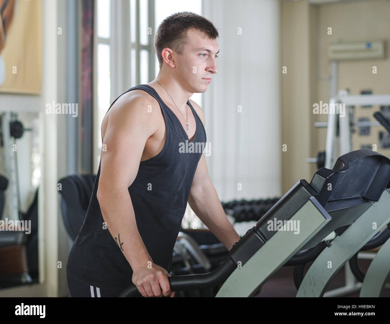 Young athlete running at the gym on the treadmill Stock Photo - Alamy
