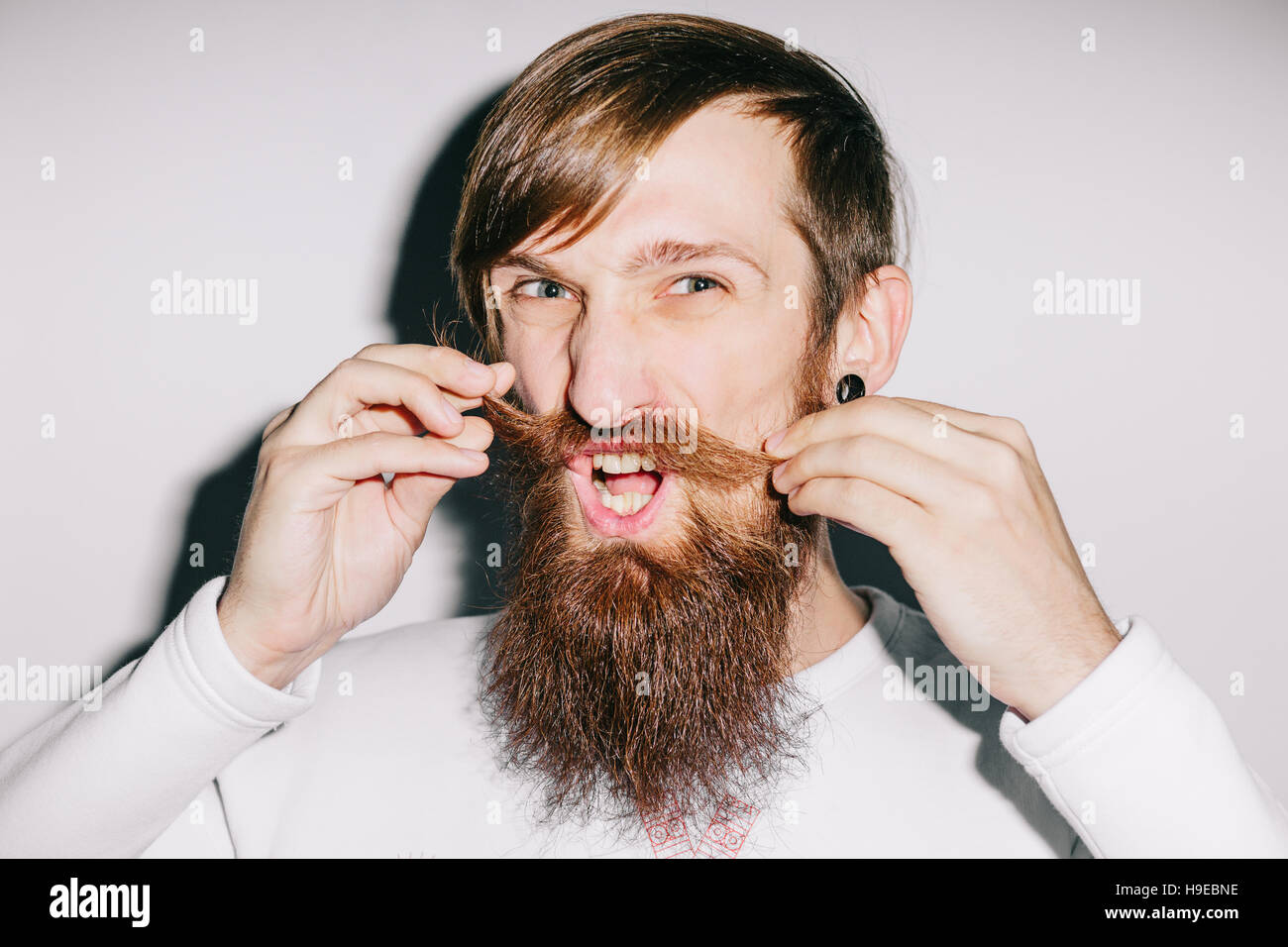 Man twirling his mustache making a face Stock Photo - Alamy