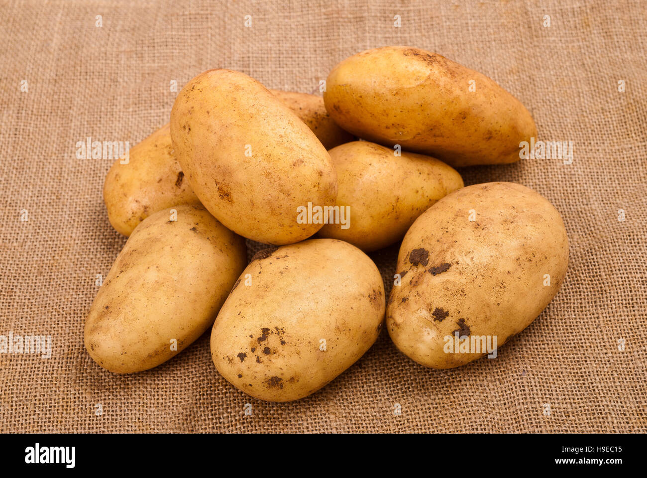 Potatoes group on jute background Stock Photo - Alamy