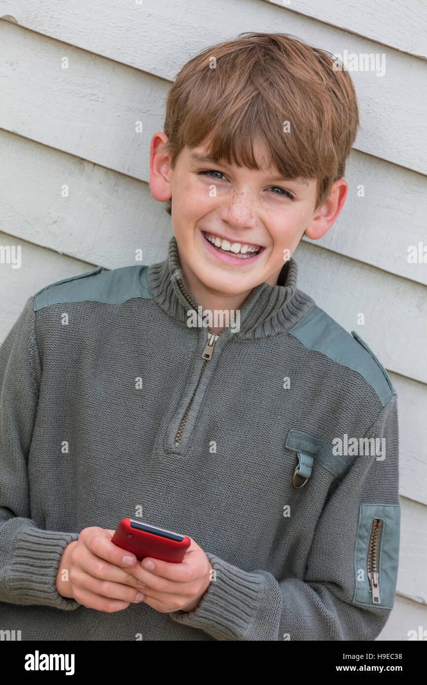 Boy child using mobile cell phone Stock Photo - Alamy