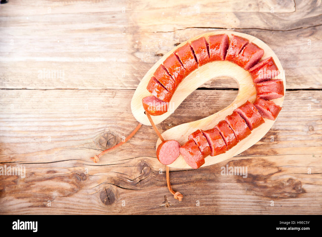 Traditional Dutch smoked sausage called Rookworst on wooden background ...