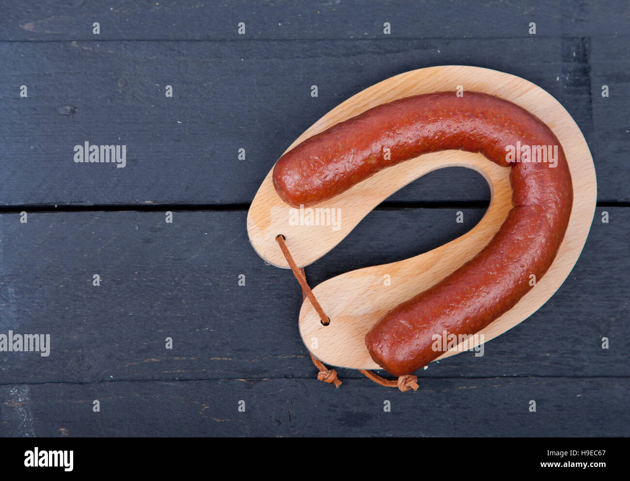 Traditional Dutch smoked sausage called Rookworst on wooden background ...
