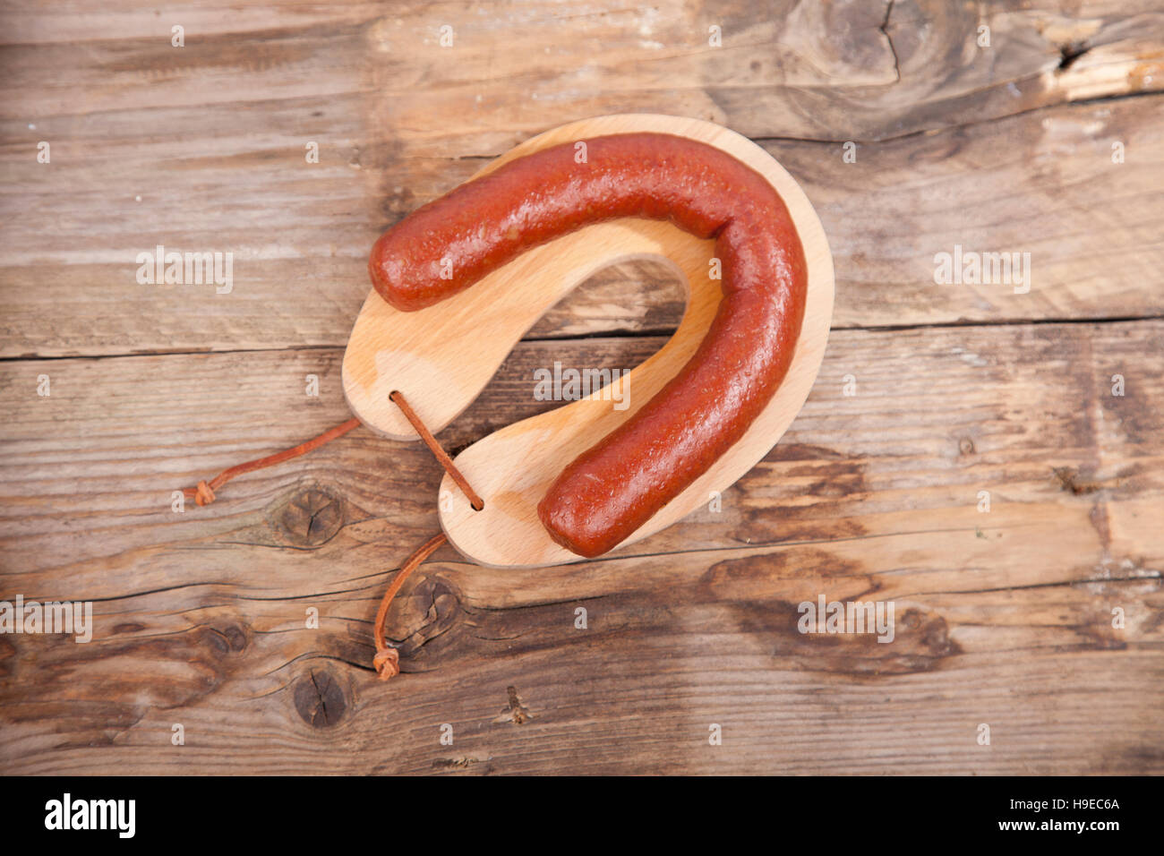 Traditional Dutch smoked sausage called Rookworst on wooden background ...