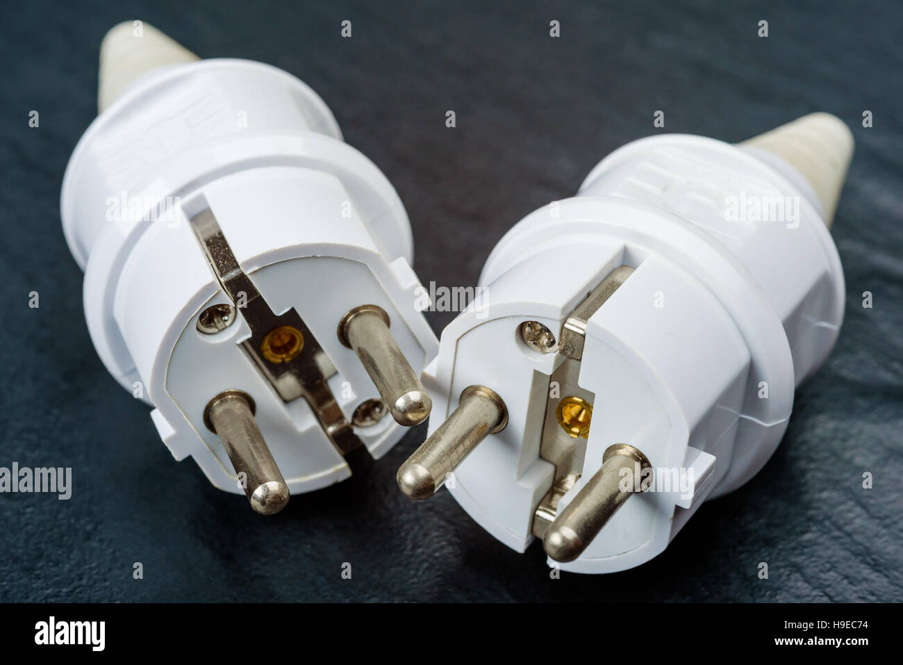 Two electric plug spare parts on dark background Stock Photo - Alamy