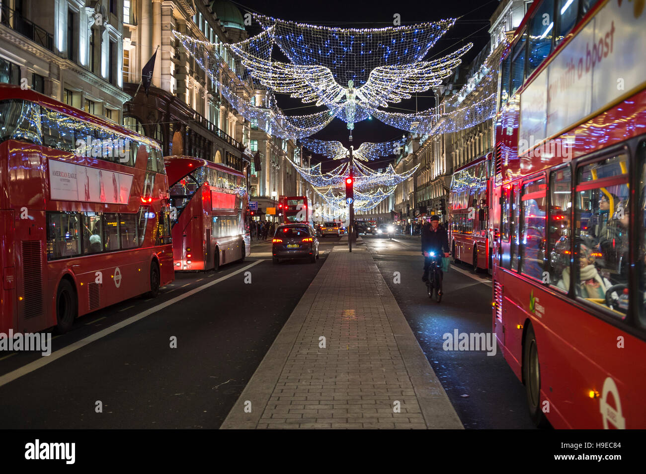 LONDON - NOVEMBER 18, 2016: Red double-decker bus pass under twinkling ...
