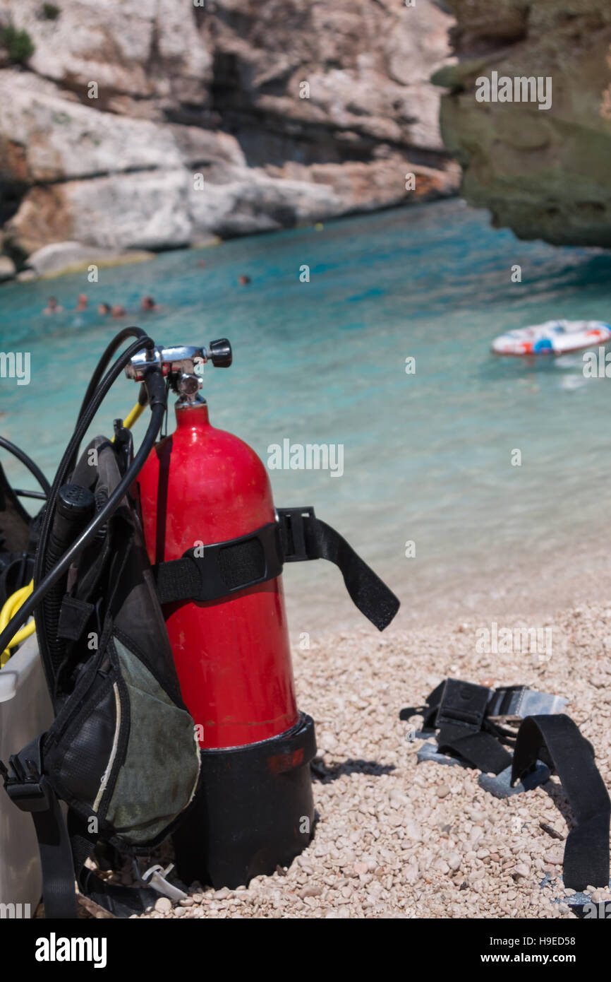 Red Scuba Oxygen Tank for Divers on a Beach, White Life Preserver on ...