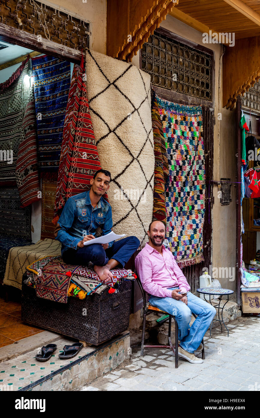 Two Carpet Sellers Outside Their Shop In The Medina, Fez, Morocco Stock ...